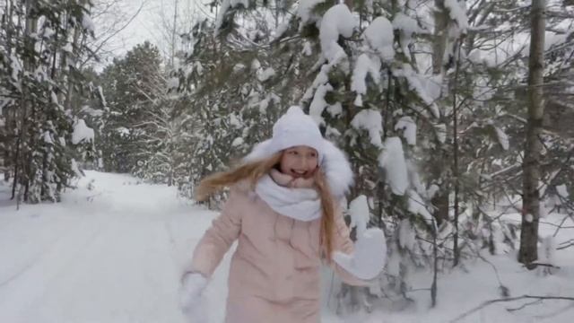 Young girl in snowy winter forest