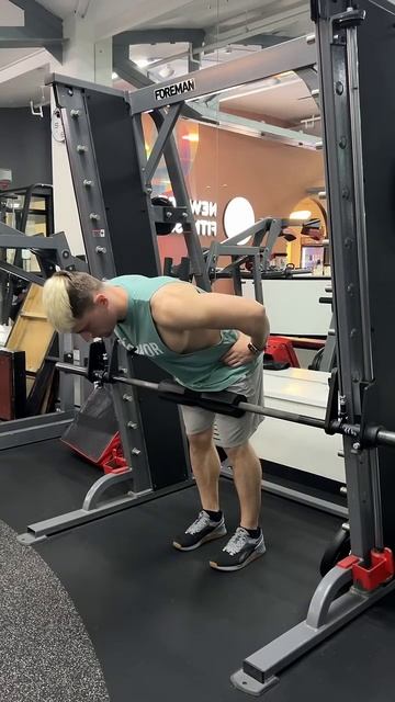 Наклоны через штангу в Смите