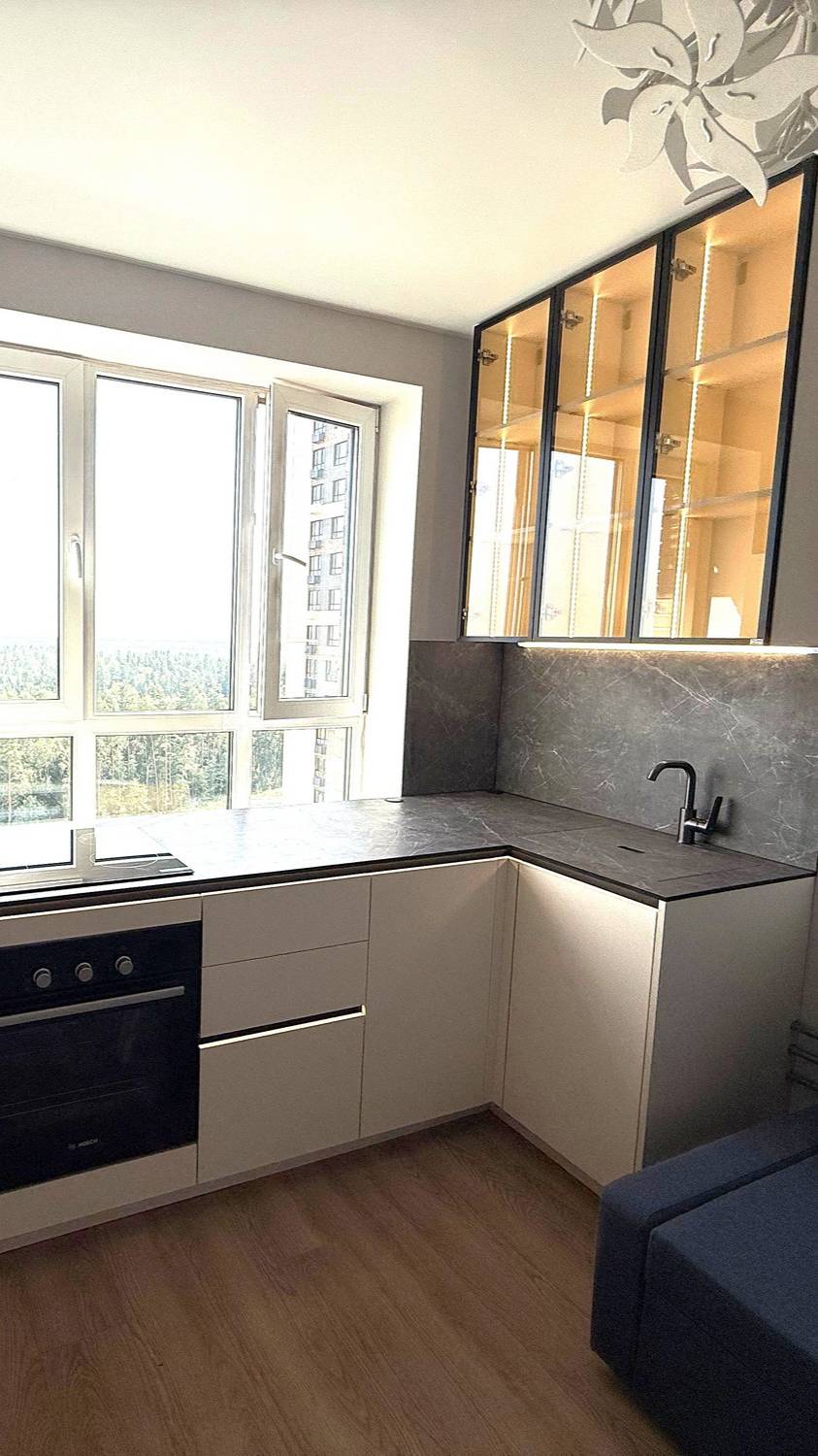 Розет - угловая белая кухня в минималистическом дизайне, с ручками Gola и стеклянными фасадами