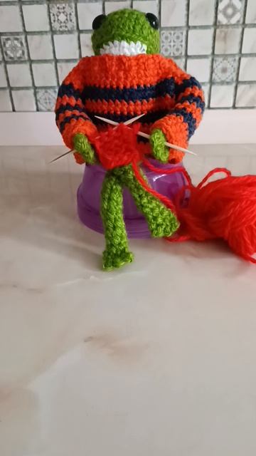 Усиленно, вяжет шарф)))