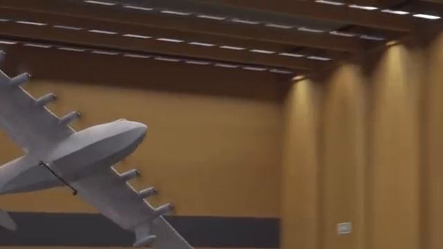 Большой радиоуправляемый самолёт с 8 электромоторами летает в зале.