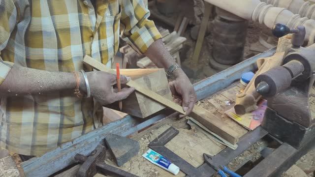 Токарь по дереву  исполняет заказ.