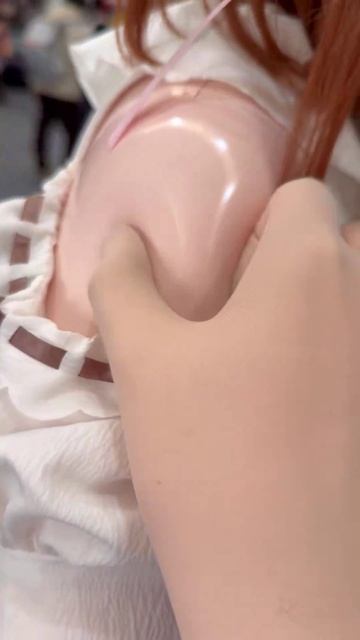 Touching Shoulder of Latex Kigurumi Doll