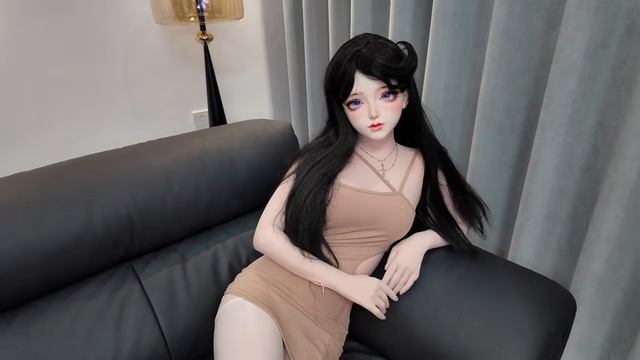 Very sexy real doll sitting on the sofa.