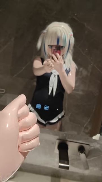 Latex Kigurumi Doll in mirror.