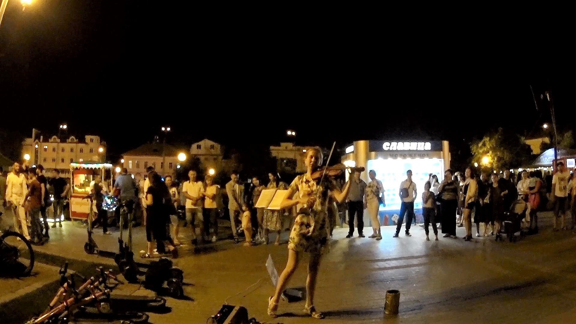 Девушка играет на скрипке.Уличные музыканты на набережной Волги.