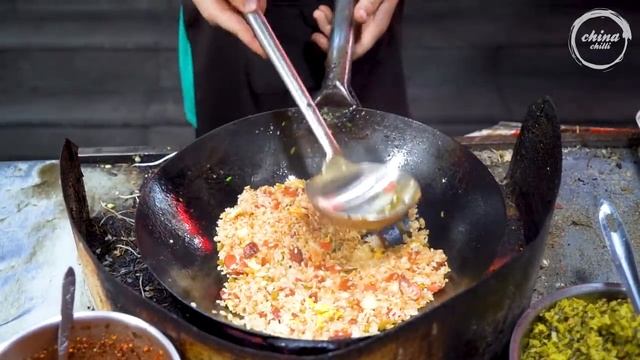 Chinese Street Food  fried rice with eggs, fried noodles, colorful fruit yogurt  at night market