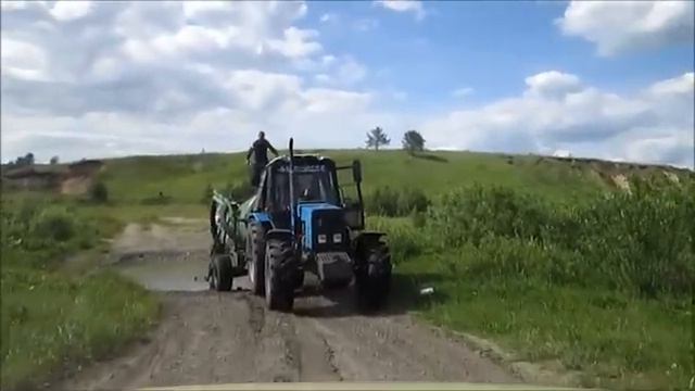 Беларус с бочкой набирает воды из речки. Трактор с бочкой