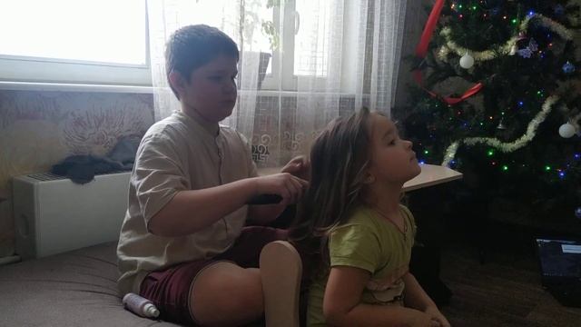 Старший брат расчёсывает младшую сестру..mp4