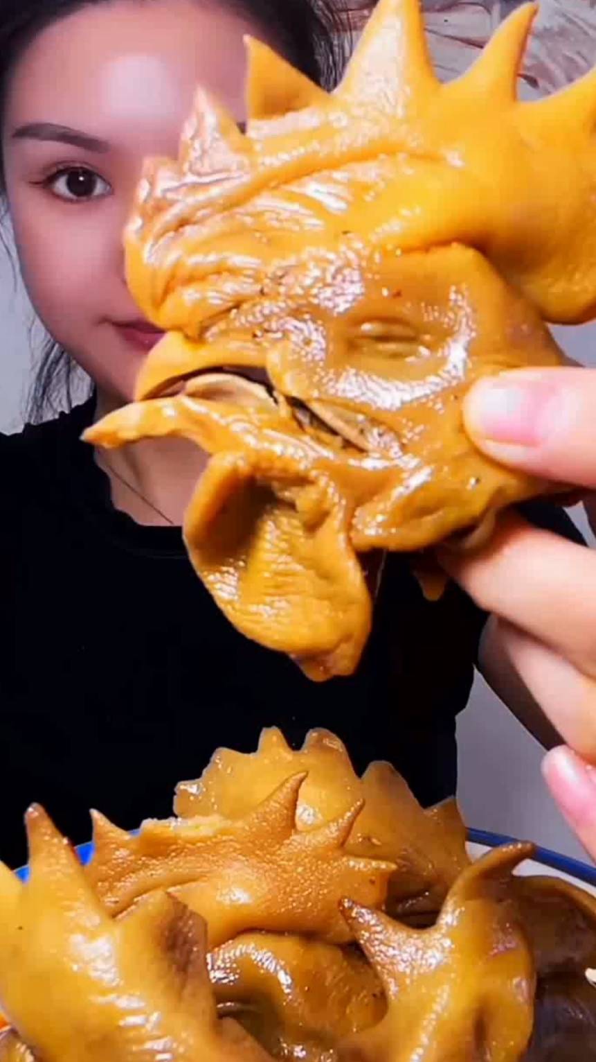 Китаянка ест куриные головы