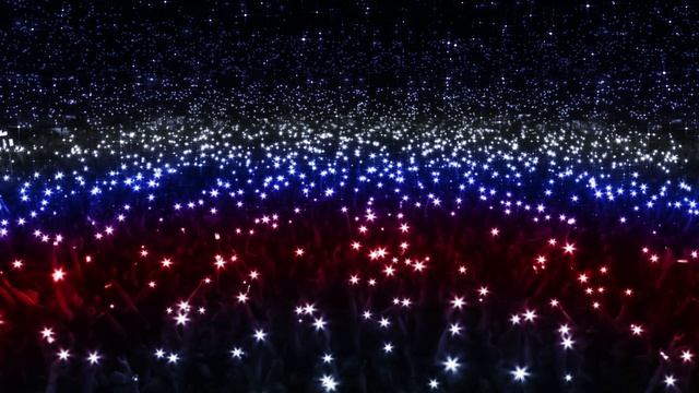 Огни на стадионе. Люди с фонариками в руках на концерте. Флешмоб. Горящие телефоны на шоу.