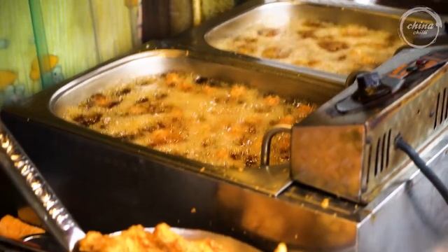 Chinese Street Food -Fried rice with chives and eggs, fire-exploded chicken drumsticks
