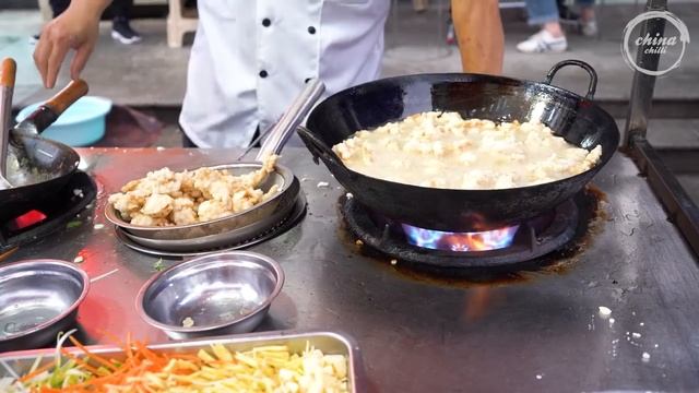 Chinese Street Food -Night market egg fried rice, northeast pot with meat